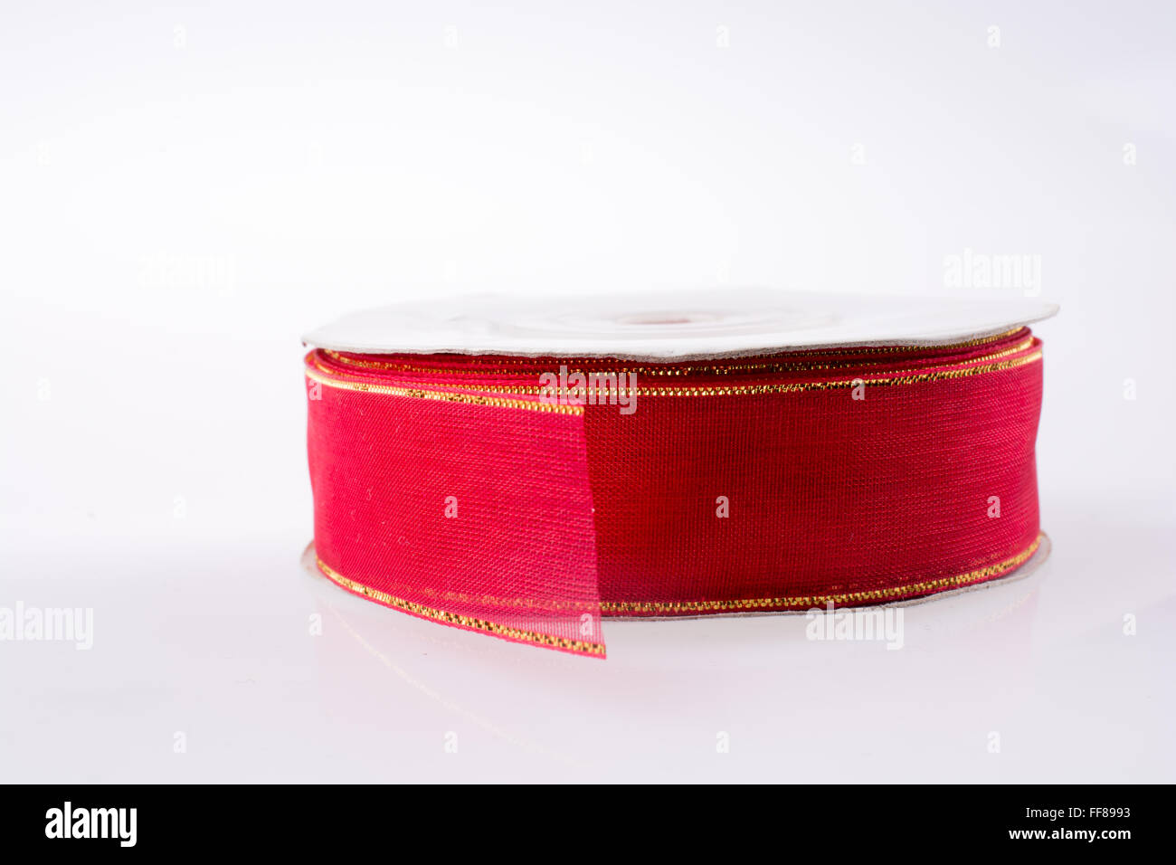 A roll of red ribbon, isolated on white Stock Photo - Alamy