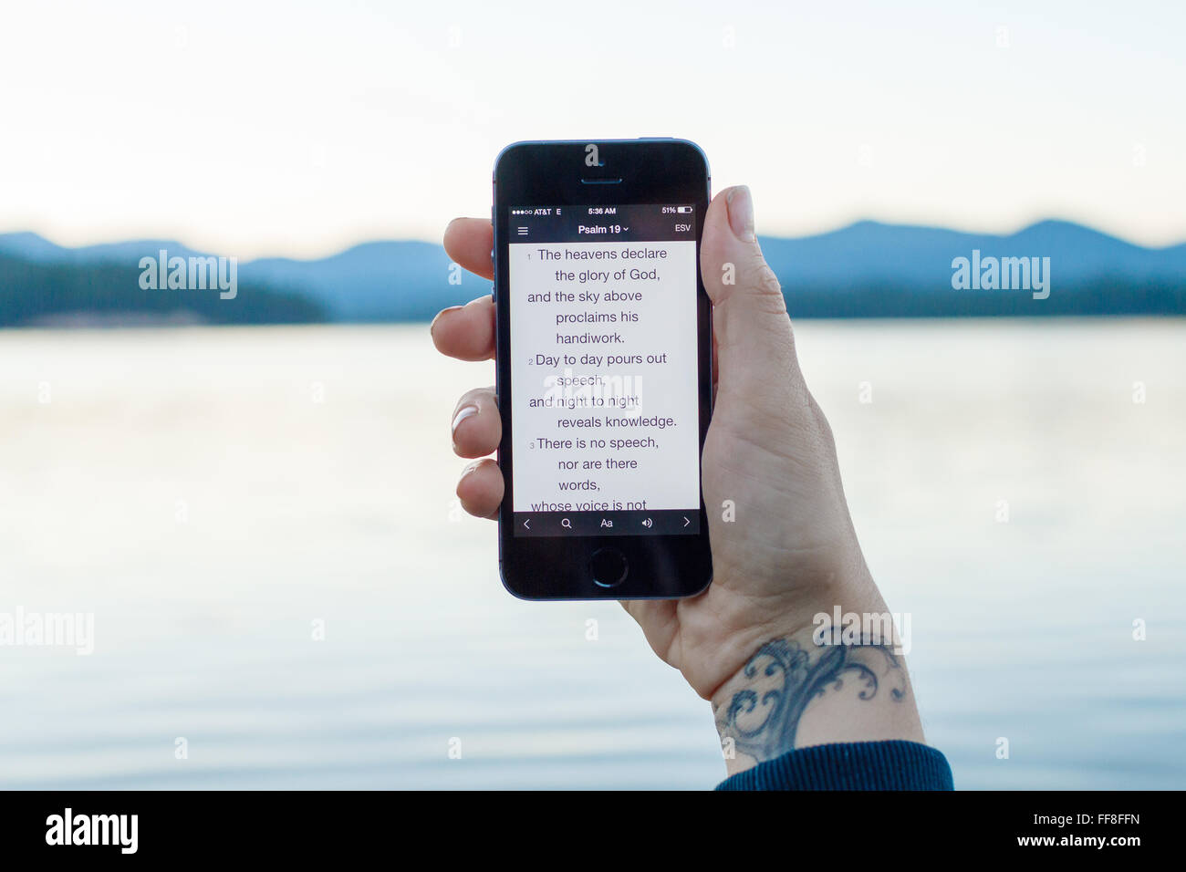 Smart phone at lake with Psalm 19 Bible verses on the screen Stock ...