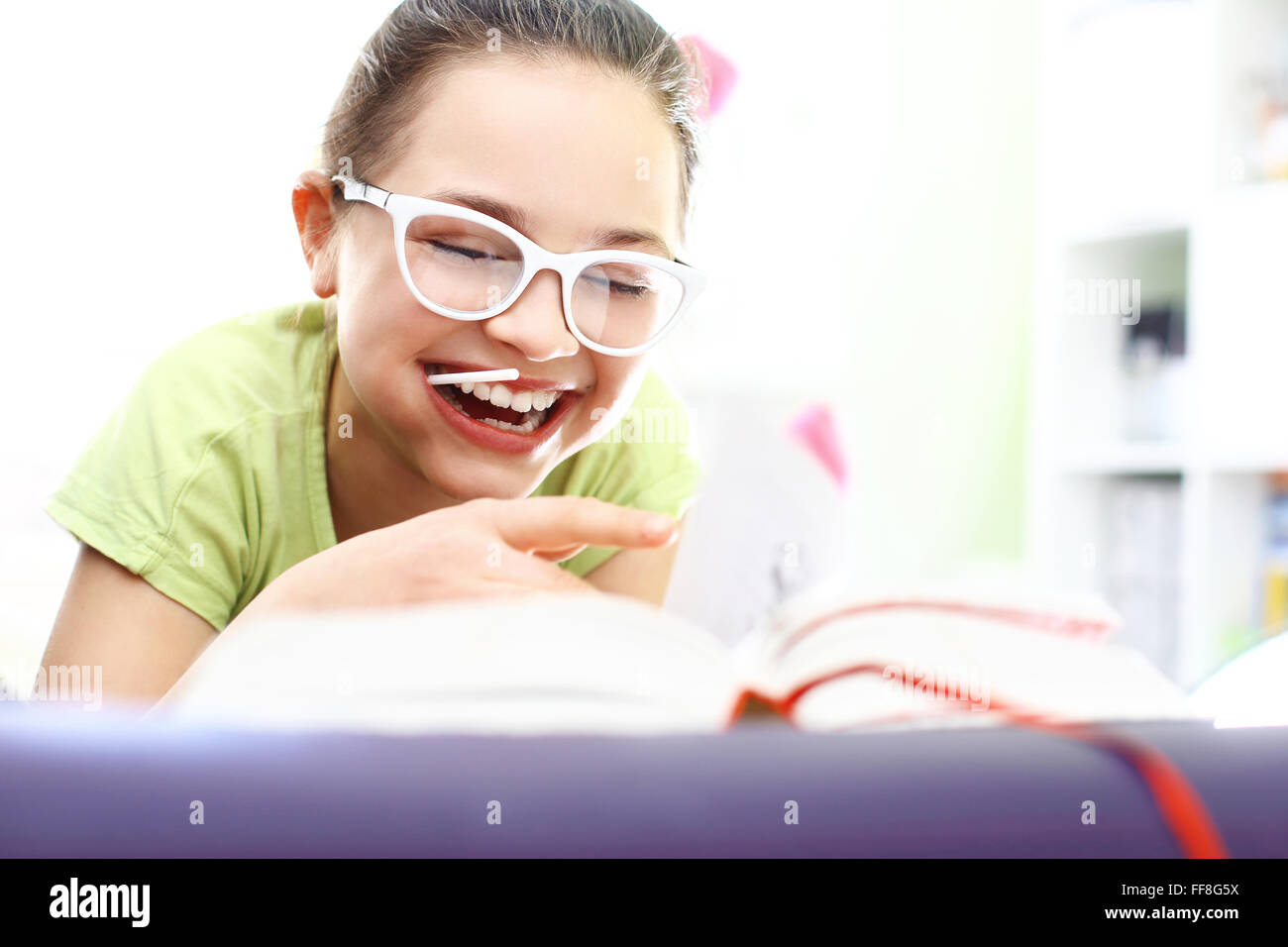 Teenager reading a book. Happy childhood, laughing girl. Reading is a ...