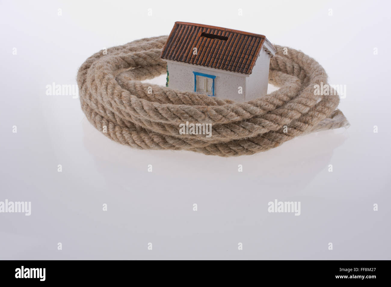 house surrounded by rope on a white background Stock Photo - Alamy
