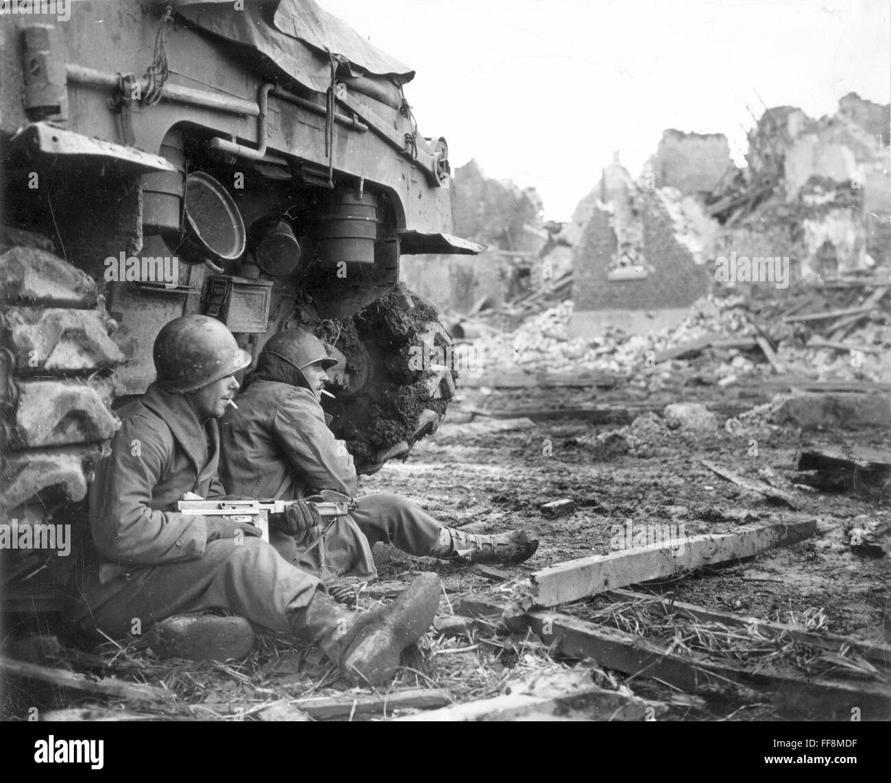 WW2: GERMANY, 1944. /nAmerican soldiers taking shelter behind a tank in ...