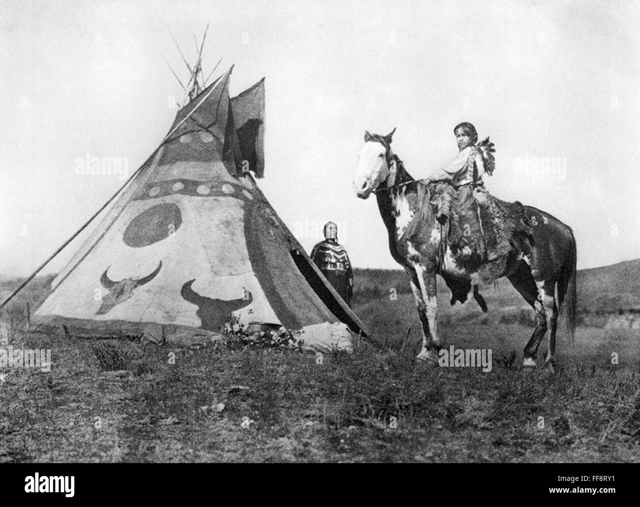 NATIVE AMERICANS, 1926. /nPainted Tepee: A young Assiniboin boy astride ...