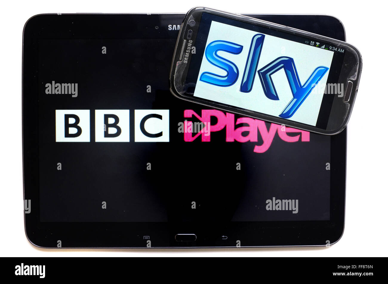 The Sky logo on a smartphone screen on top of a tablet displaying the ...