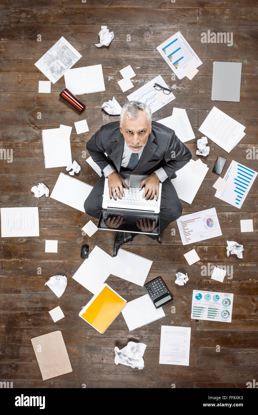Top view photo of senior businessman on wooden floor Stock Photo - Alamy