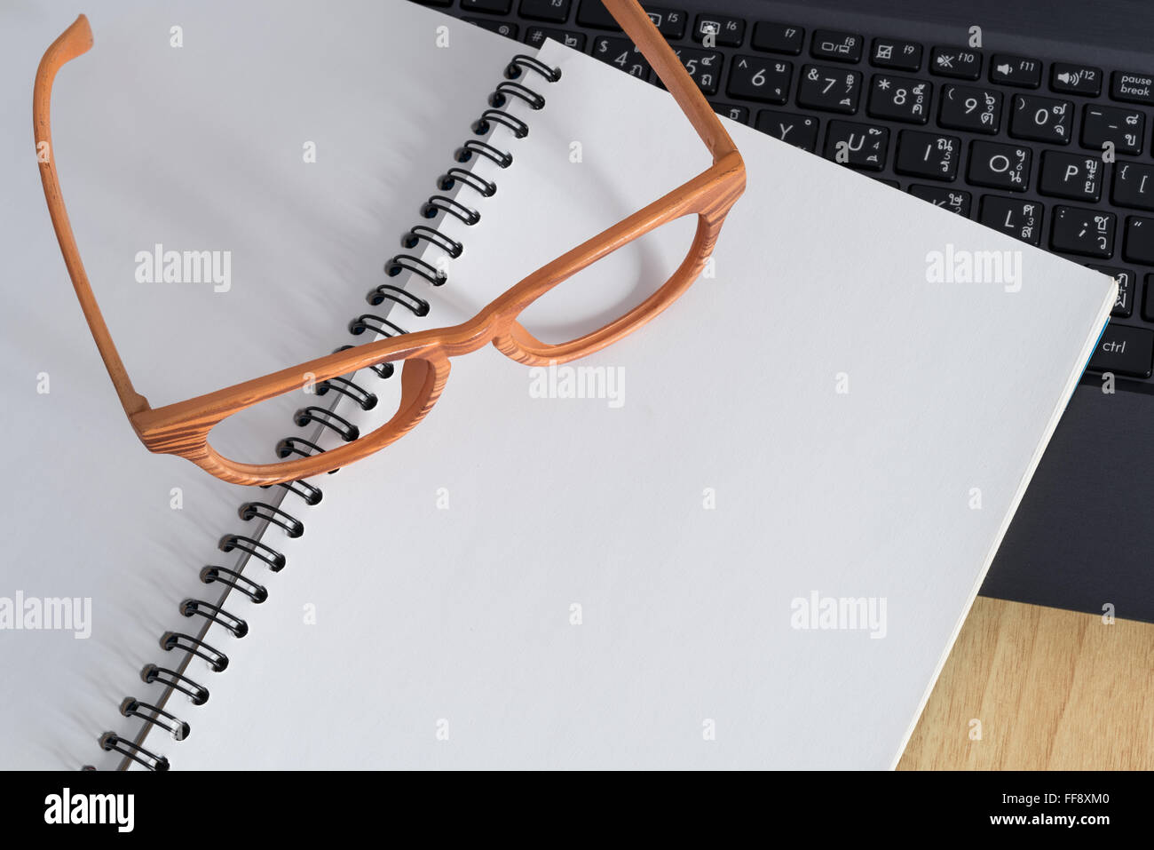 Vintage Eyeglasses and a notebook on laptop computer Stock Photo - Alamy