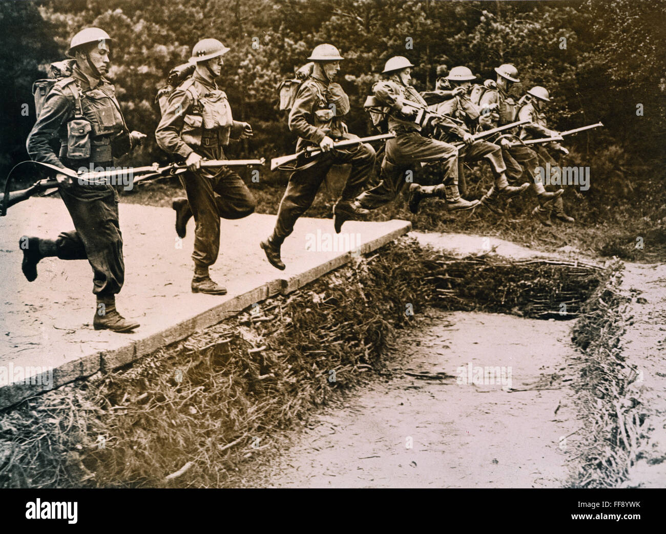 WII: BRITISH TRAINING 1941. /nBritish Guardsmen in full kit leaping a ...