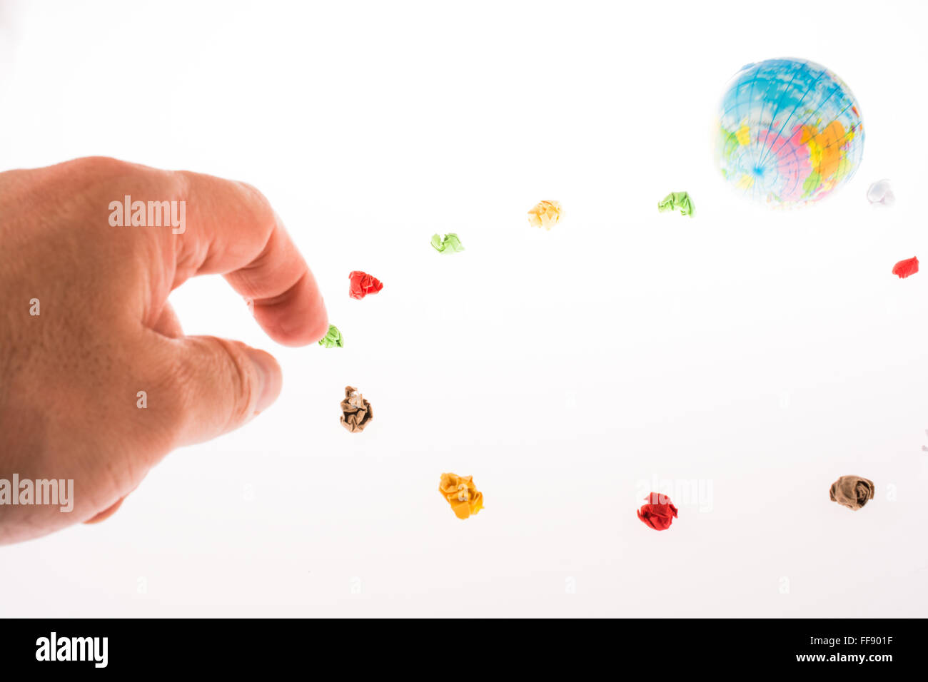 globe orbit and hand touching crumpled papers on a white background ...