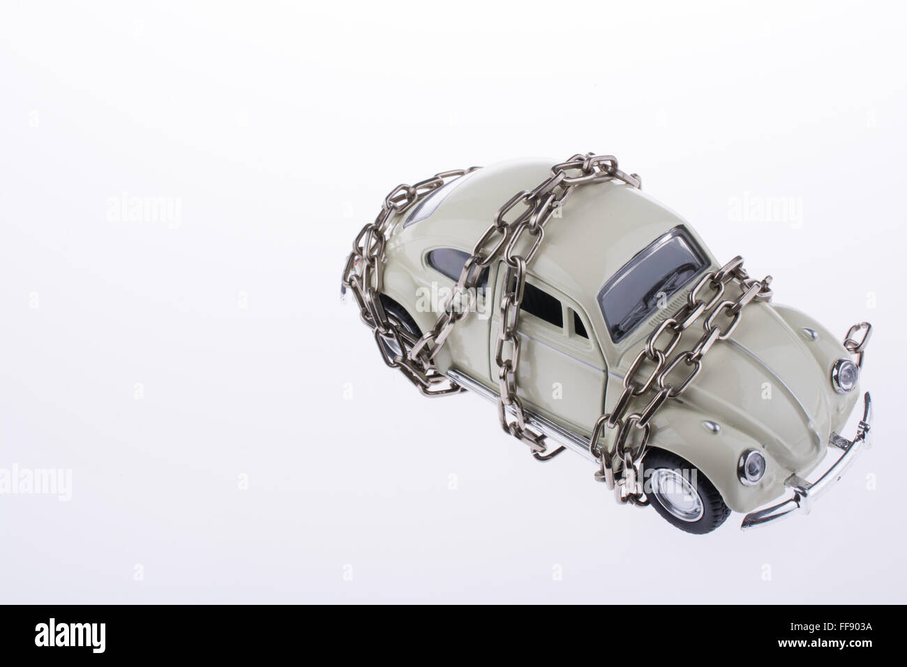 Chained white car on white background Stock Photo - Alamy