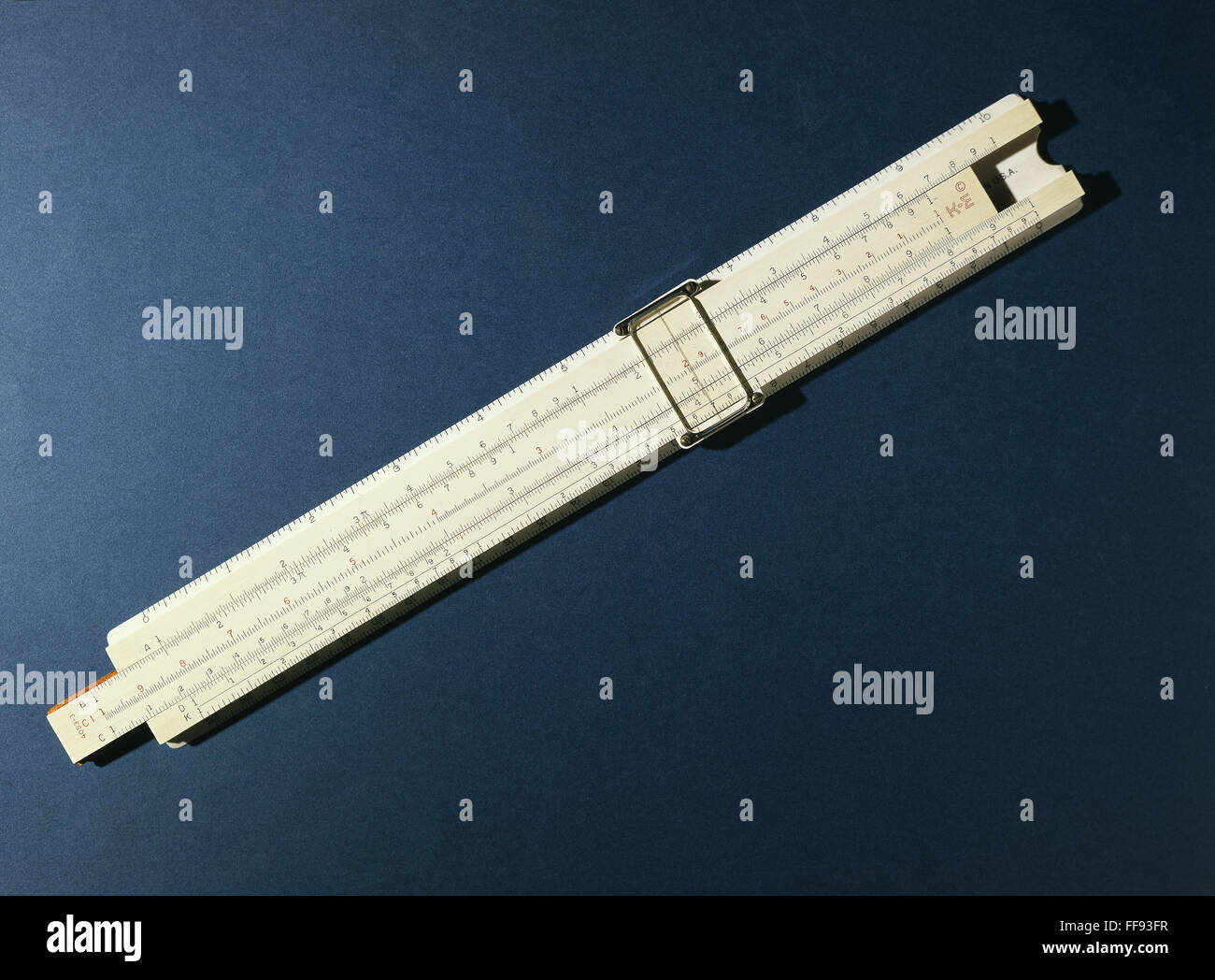 SLIDE RULE. /nA ruler and medial slide marked with logarithmic scales ...
