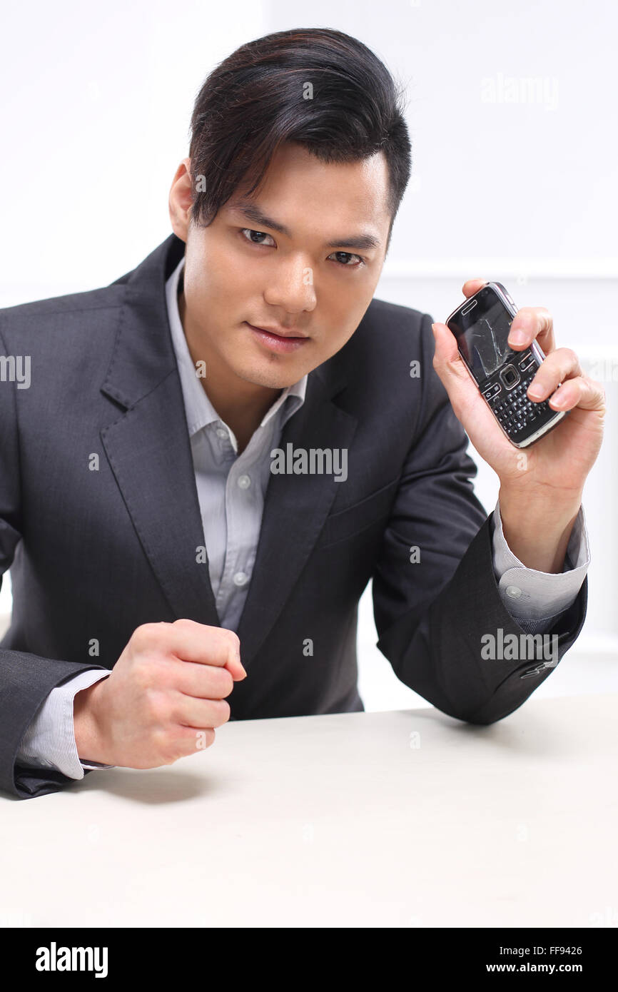 Handsome man in business suit sitting at his desk in his office. Office ...