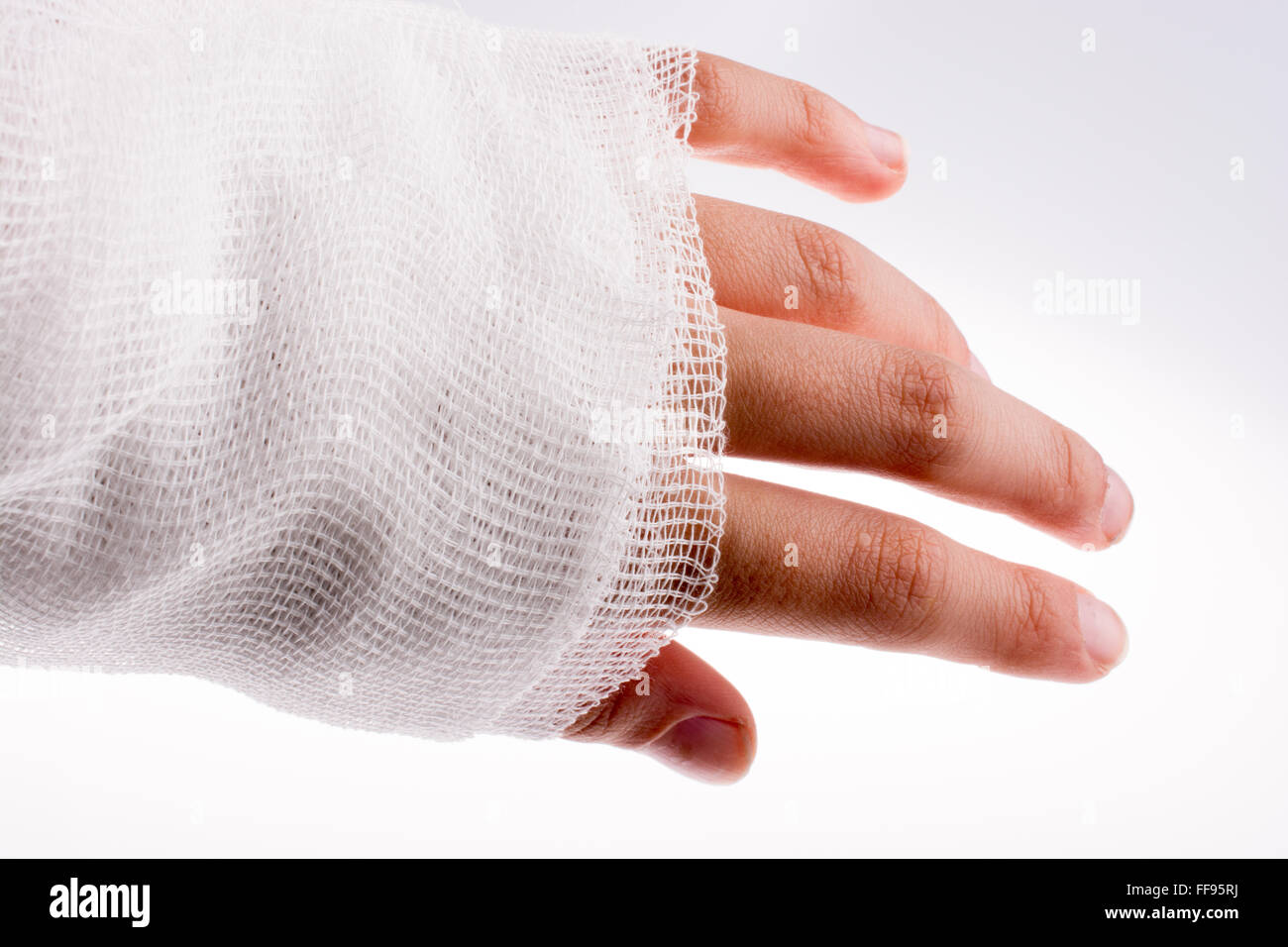 hand wrapped in white bandage on a white background Stock Photo - Alamy