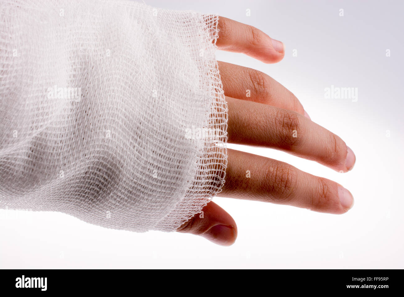 hand wrapped in white bandage on a white background Stock Photo - Alamy