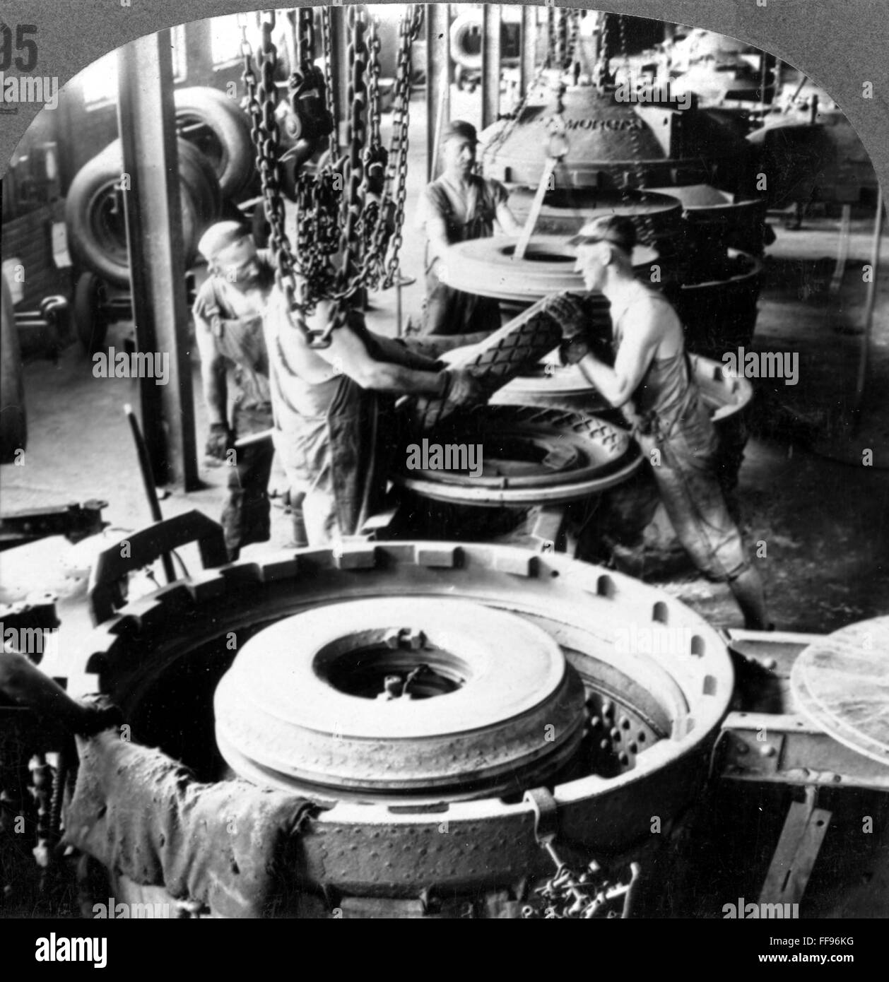FACTORY: GOODYEAR TIRES. /nTaking automobile tires from the curing pits ...