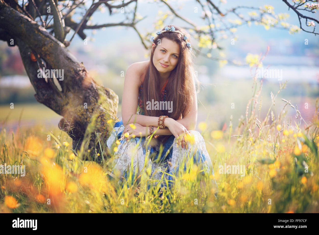 Smiling gypsy woman posing among flowers . Peace and harmony Stock ...