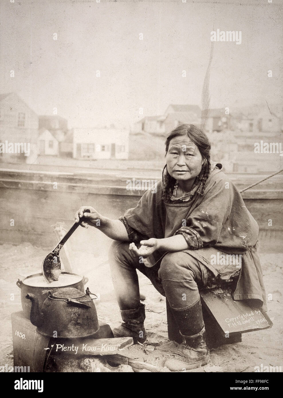 ALASKA: ESKIMO WOMAN, 1904. /nAn Eskimo woman cooking out of doors in ...