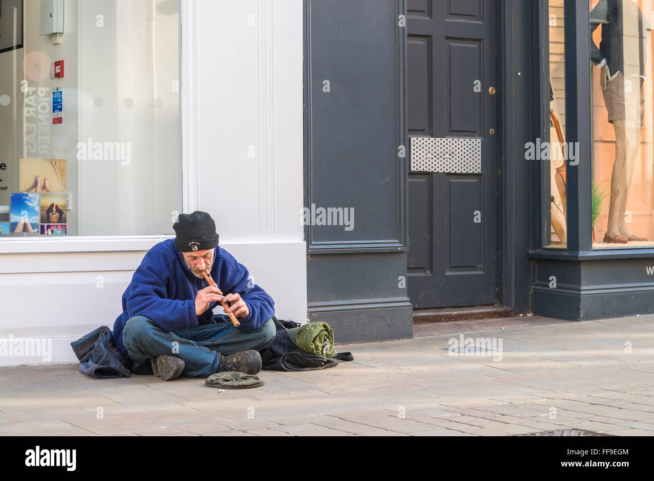 Homeless play with Flautist Stock Photo - Alamy