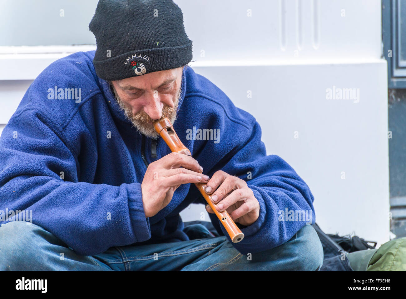 Homeless play with Flautist Stock Photo - Alamy