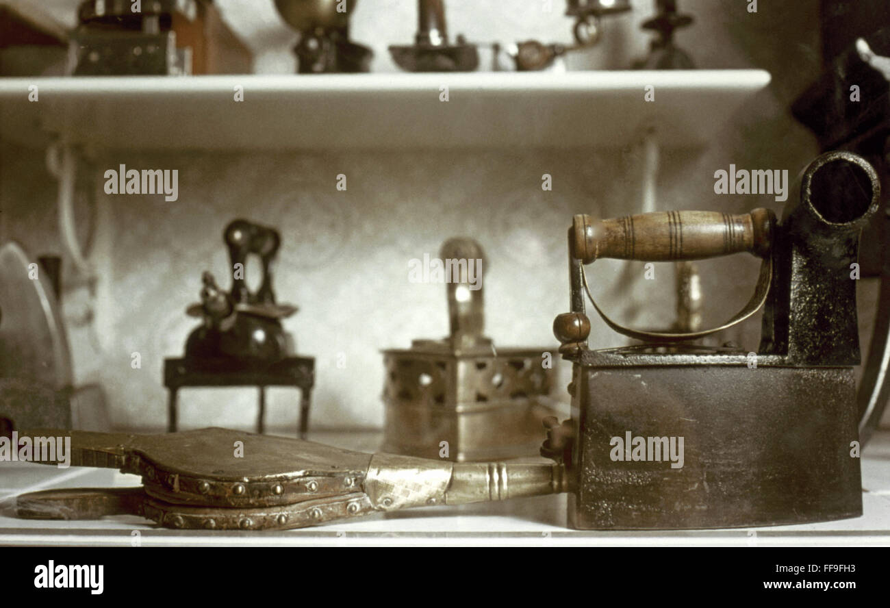 IRON, 19th CENTURY. /nA charcoal iron with bellows, foreground, and ...