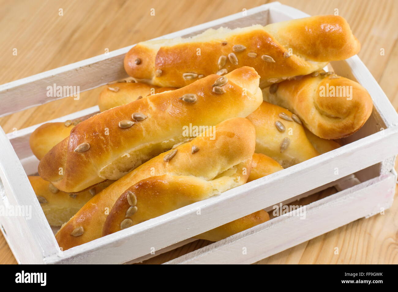 sesame pastry in a white crate on a wooden table Stock Photo - Alamy