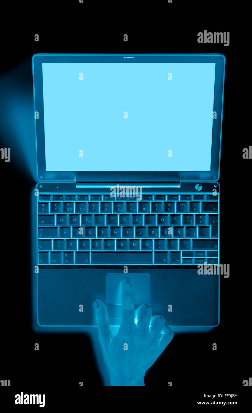Portable computer with hand and blue tones. Vertical Stock Photo - Alamy