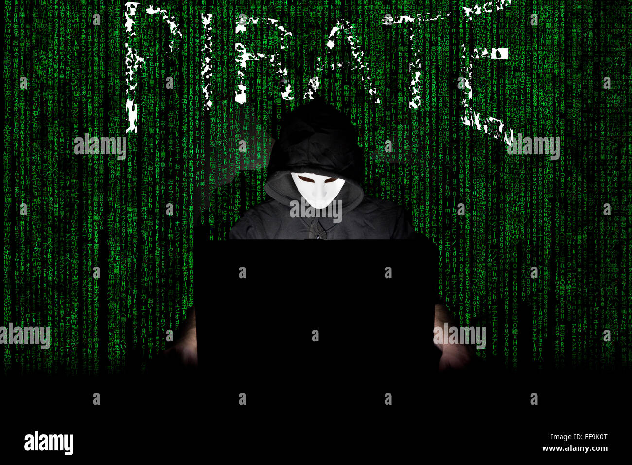 A masked man at a laptop symbolising the dangers of the Internet Stock ...