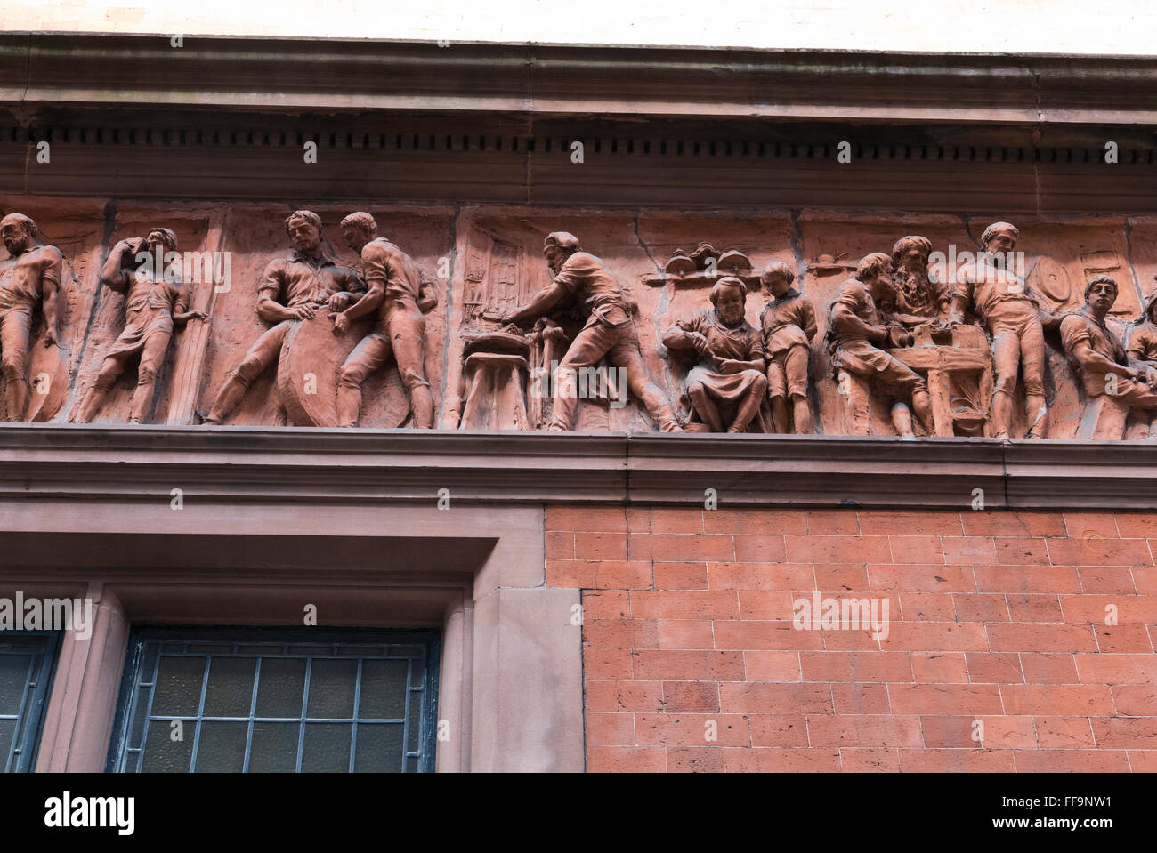 Stone carvings of men at work on the exterior wall of the Worshipful ...