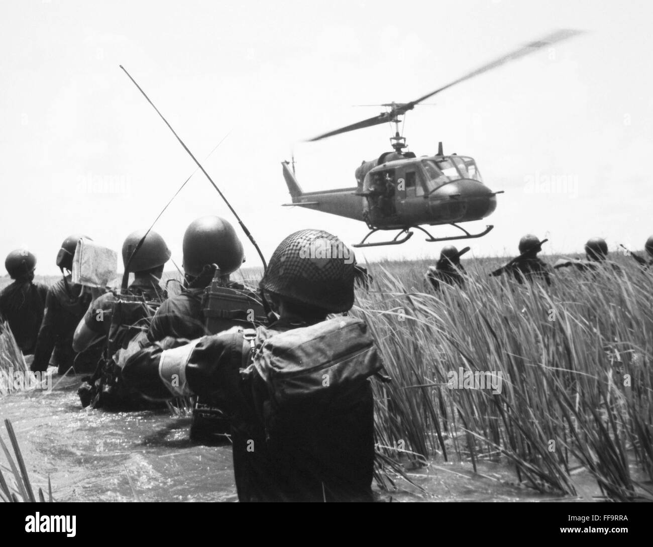 VIETNAM WAR, 1964. /nA Vietnamese reconnaissance unit walks hip-deep in ...