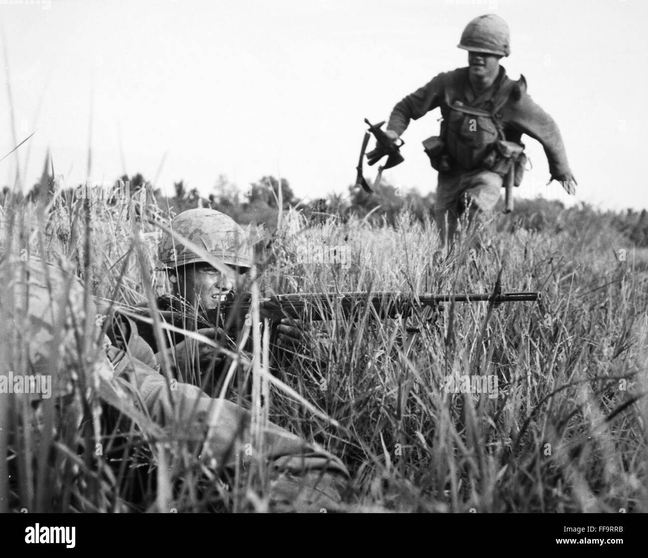 VIETNAM WAR: RICE PADDY. /nA U.S. infantryman runs through a rice paddy ...