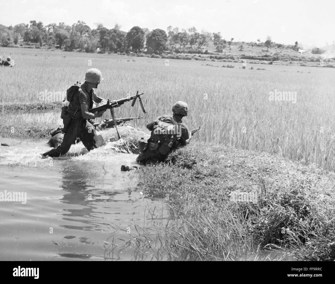VIETNAM WAR: RICE PADDY. /nFiring from the hip, a U.S. Marine machine ...