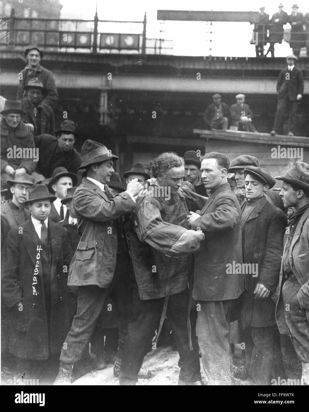 HARRY HOUDINI (1874-1926). /nAmerican magician. Houdini is assisted ...