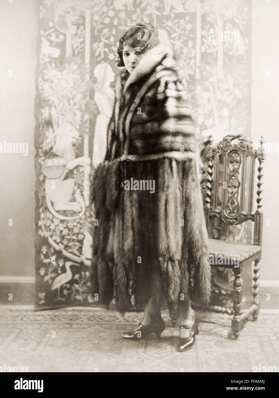 FASHION: FUR, 1925. /nAmerican actress Helen Ferguson wearing a heavy ...