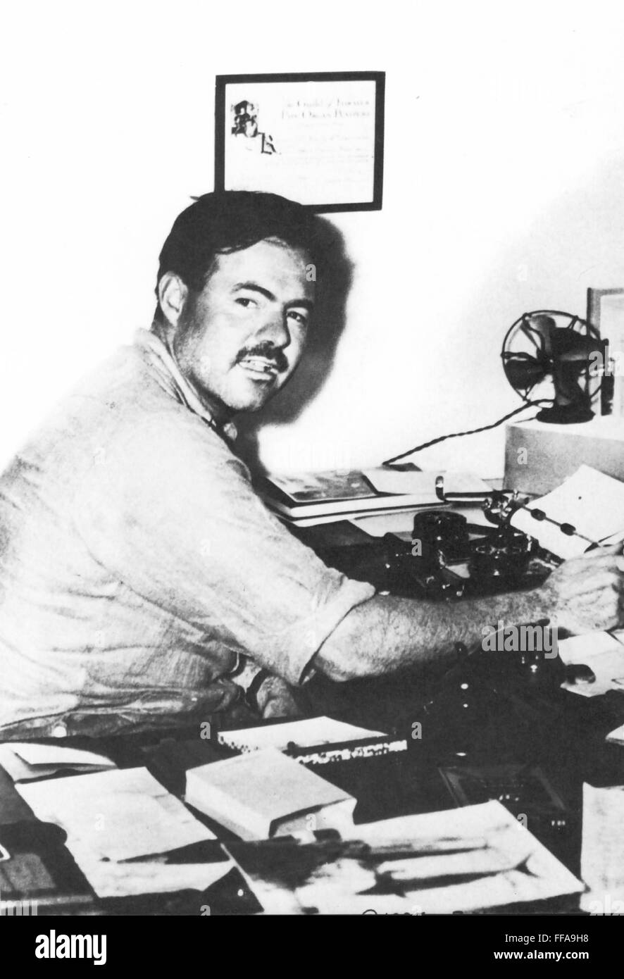 ERNEST HEMINGWAY /n(1899-1961). American writer. At the typewriter in ...