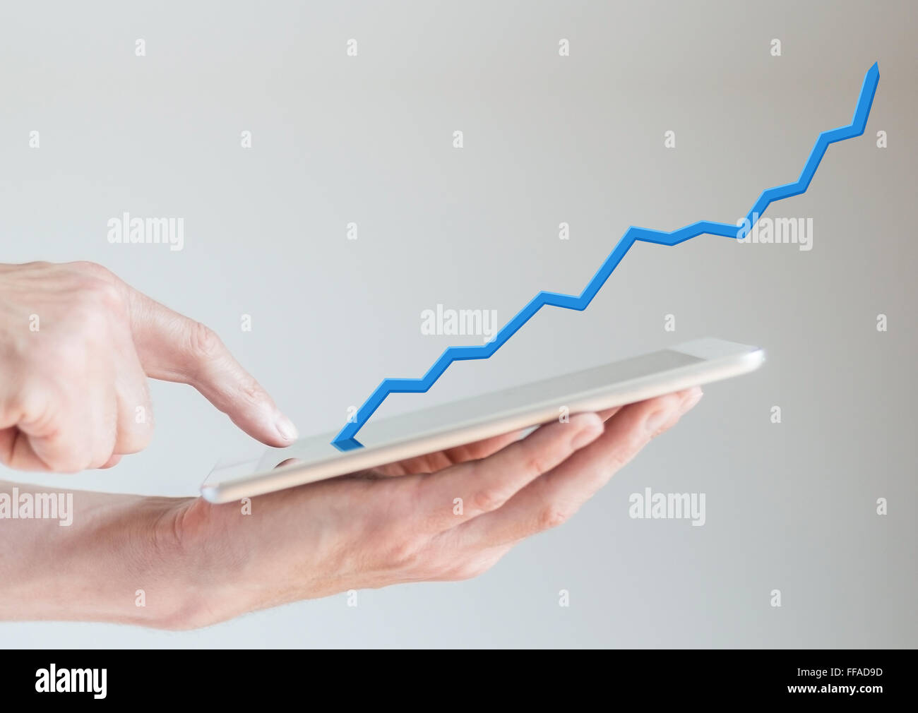 Hand holding tablet. Concept of increasing sales from mobile online ...