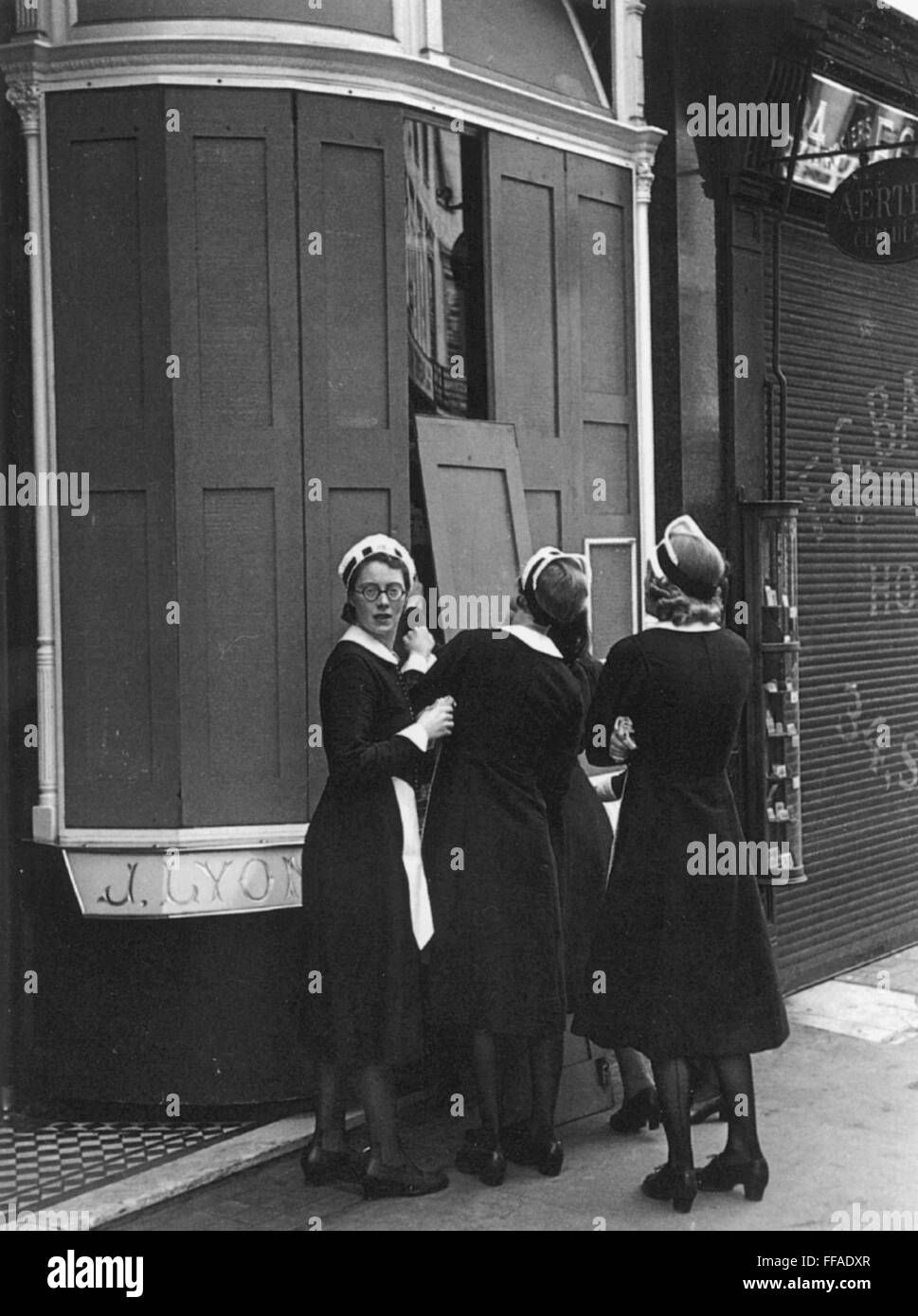 LONDON: BLACKOUT, 1940. /nWaitresses install wooden shutters outside a ...