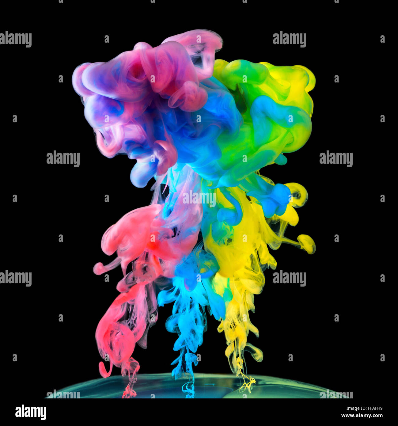 Colored inks in water on black background Stock Photo - Alamy
