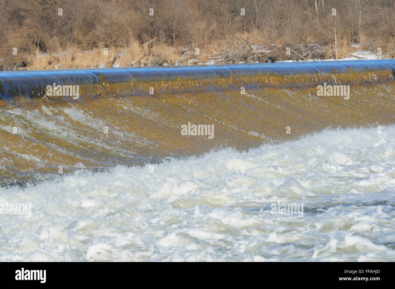 Water flowing over dam on river Stock Photo - Alamy