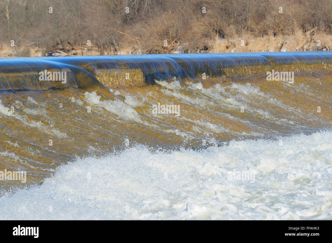 Water flowing over dam on river Stock Photo - Alamy