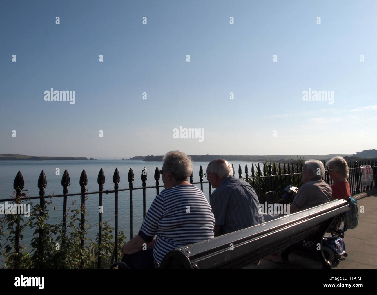 Four sitting on a seaside bench hi-res stock photography and images - Alamy