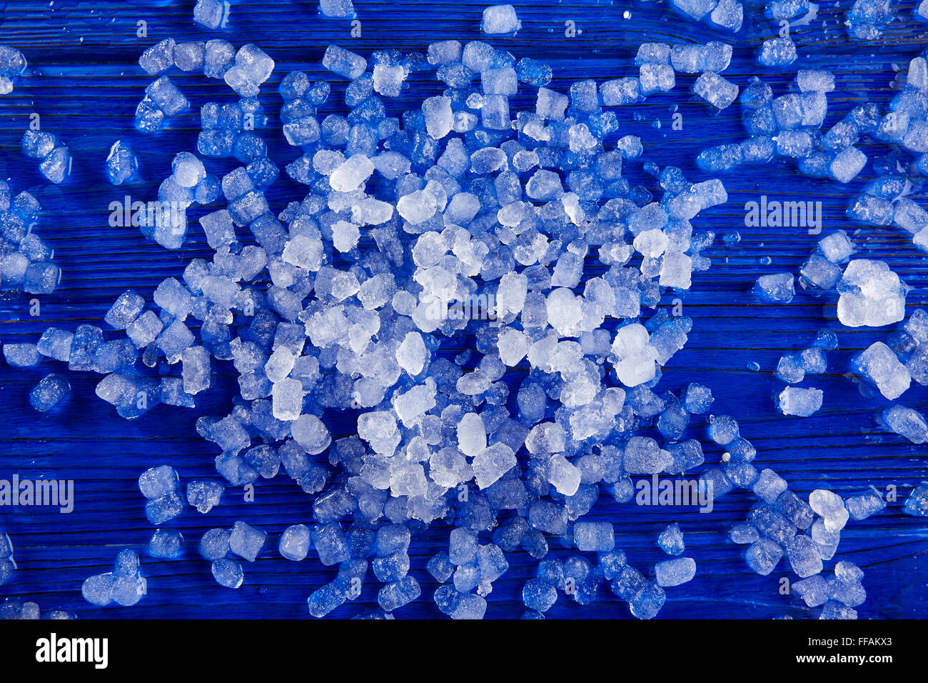 little ice cubes over blue wood background Stock Photo - Alamy