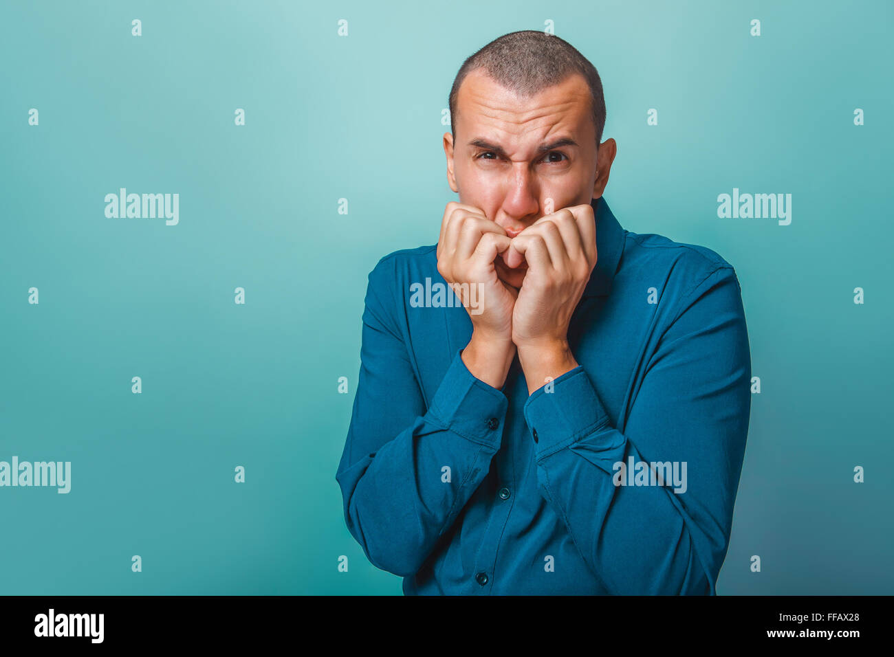 a man of European appearance thirty years chewing fingernails o Stock ...