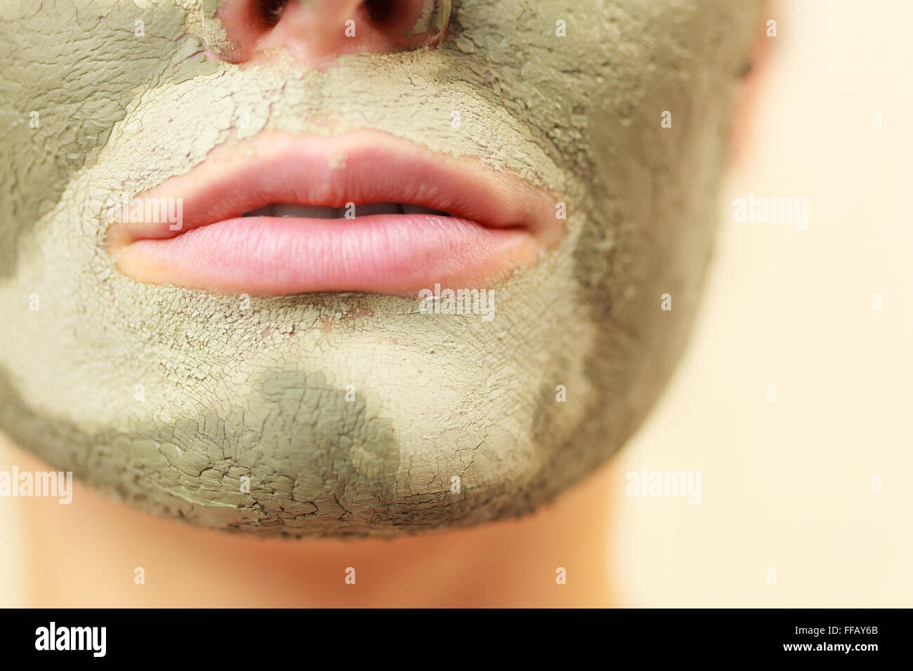 Skin care. Woman face with green clay mud mask close up. Girl taking ...