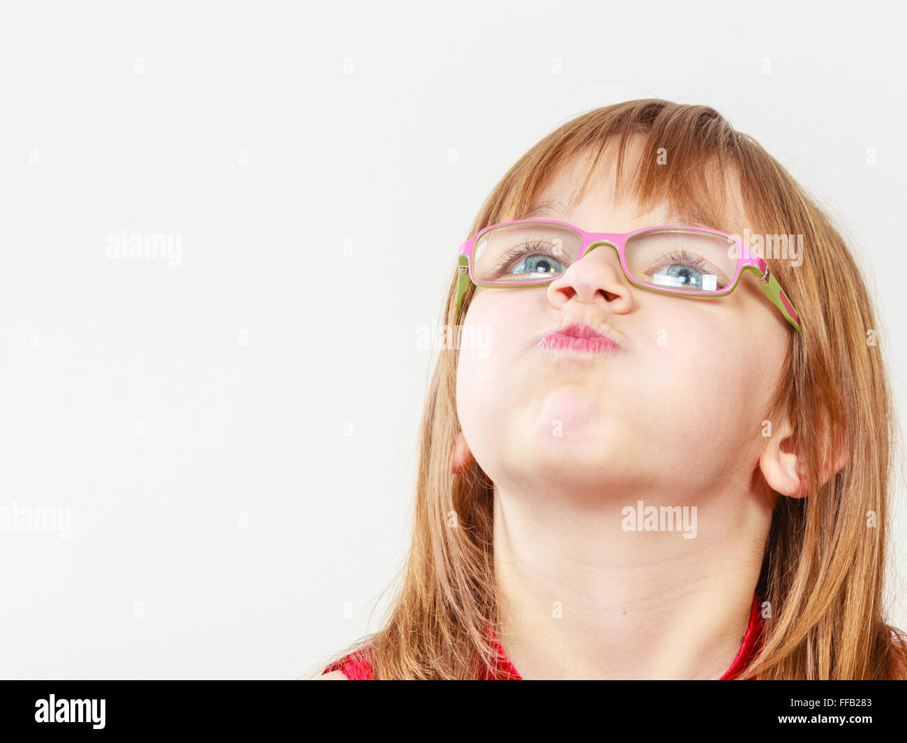 Play and fun. Charming little girl making funny crazy face. Smiling ...