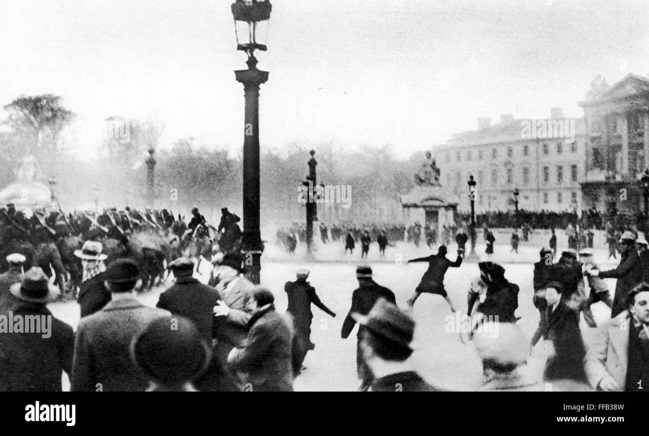 FRANCE: PARIS RIOTS, 1934. /nA rioter hurling a missle from behind ...
