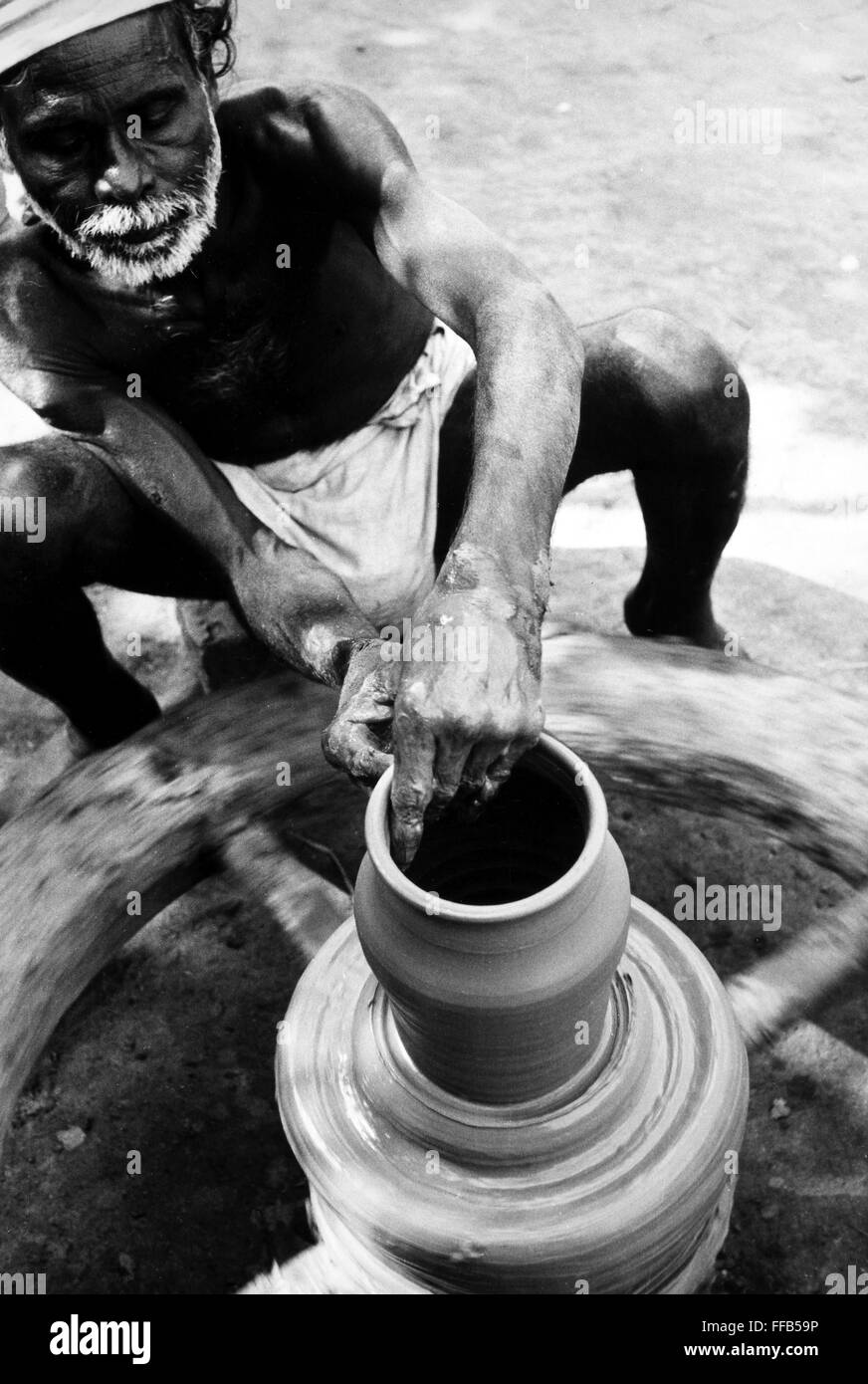 INDIAN POTTER, 1963. /nAn Indian potter spins his earthenware into ...