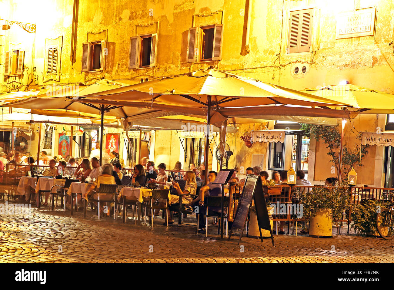 A cafe in Piazza Santa Maria in Trastevere in Rome at night Stock Photo ...