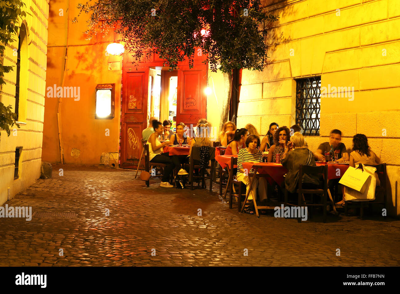 A cafe in a cobblestone street in the Trastevere district of Rome at ...