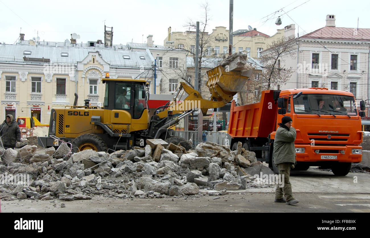 Moscow, Russia. 11th Feb, 2016. A wheel loader lifts leftovers of a ...