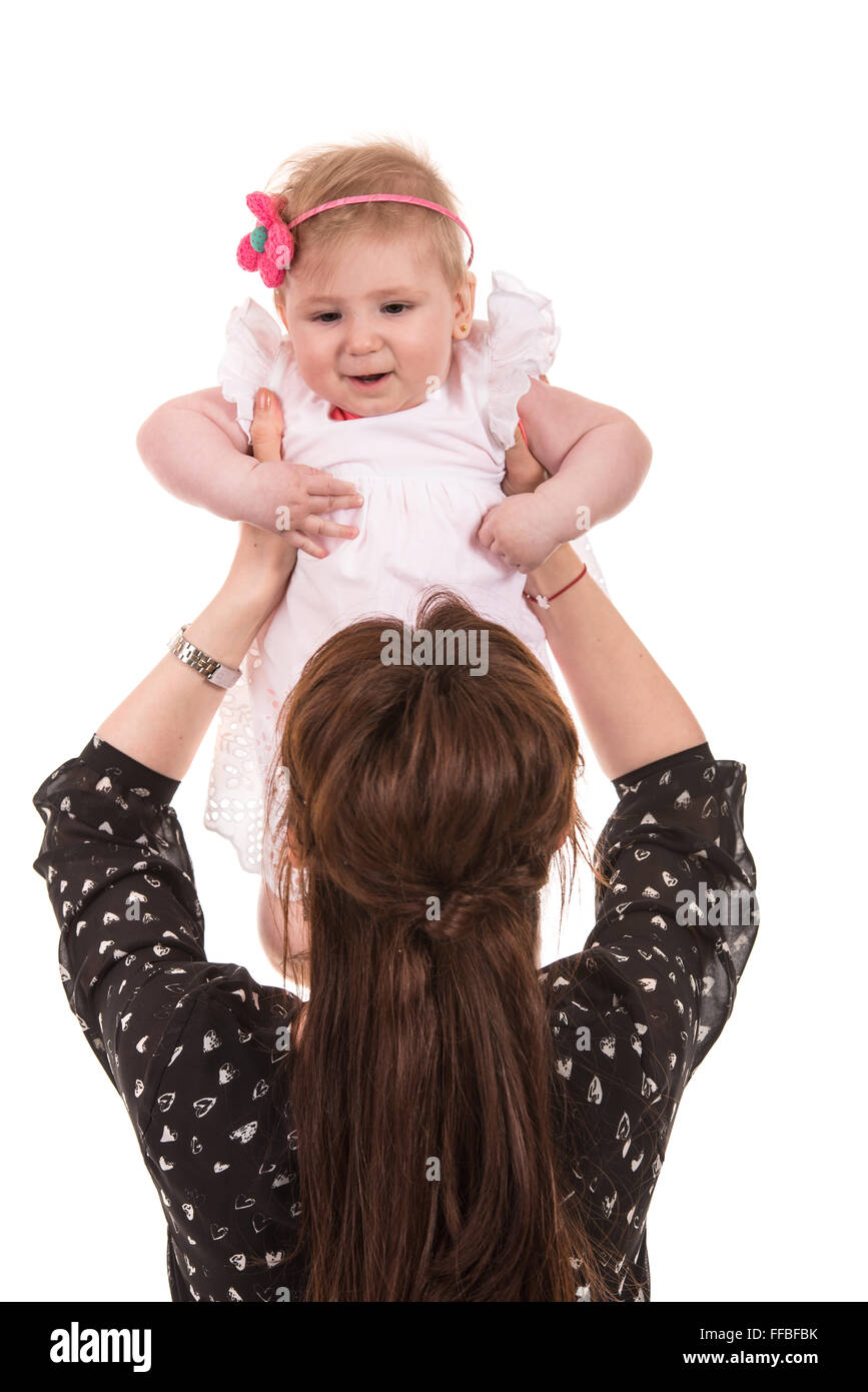 Back of mother raising her baby girl isolated on white background Stock ...