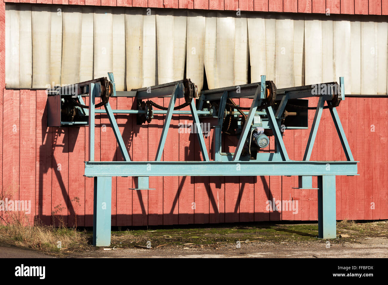 An empty machine part on the outside of a sawmill. Planks normally come ...