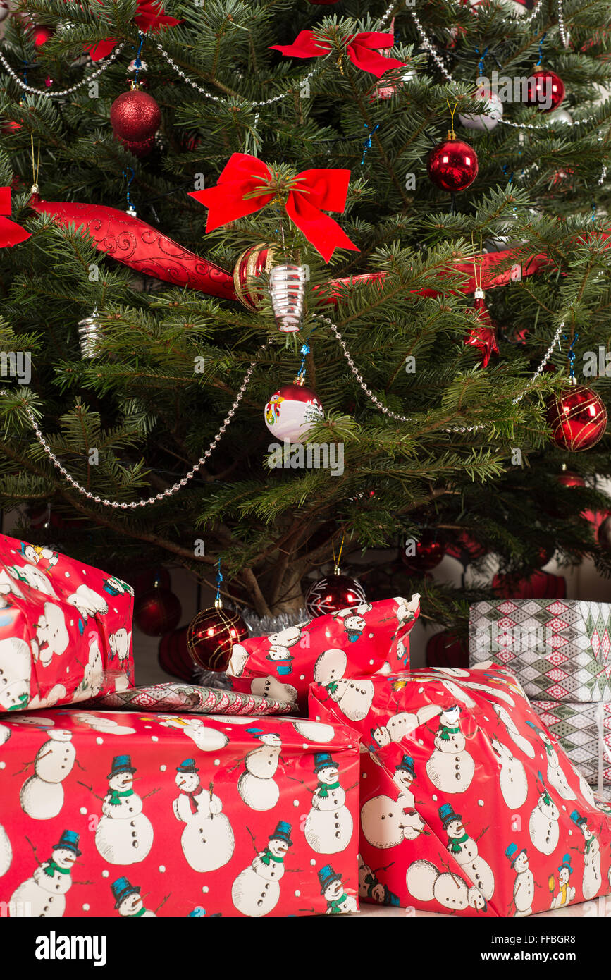 Beautiful natural Christmas tree with decorations and gifts under tree ...